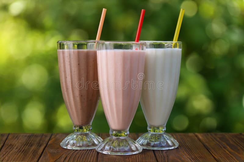 Set of Different Delicious Milkshakes in Glasses with Straw on Table ...