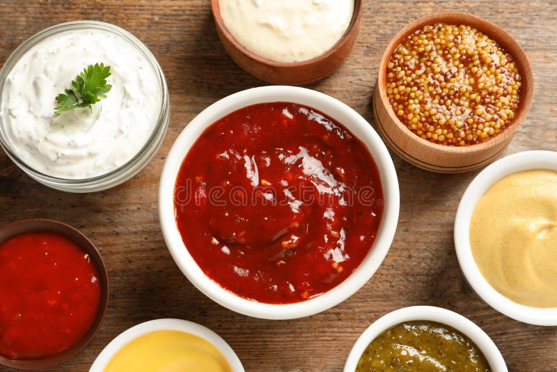 Set of Different Delicious Sauces on Wooden Table Stock Photo - Image ...
