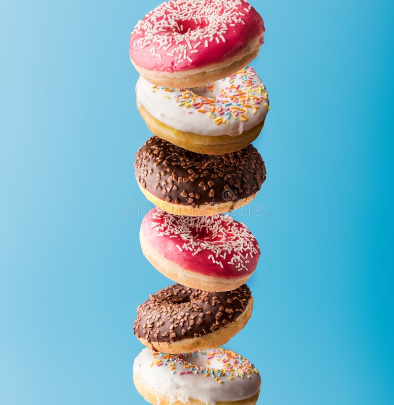 Set of Different Donuts Flying in the Air Along with Decorative Powder ...