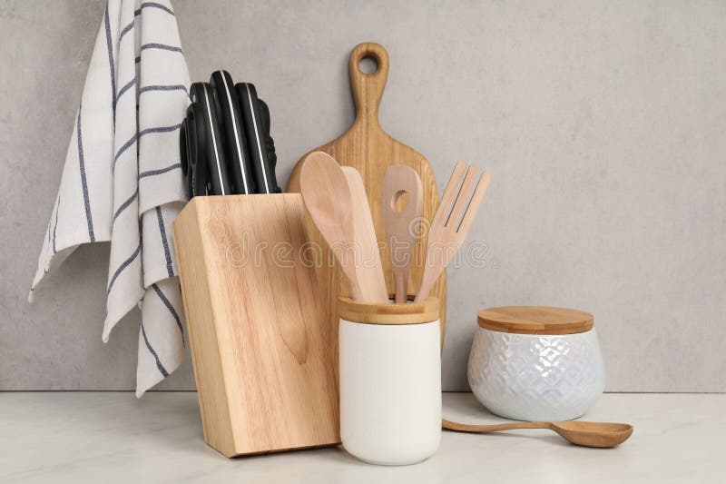 Set of Different Kitchen Utensils on White Near Gray Wall Stock Photo ...