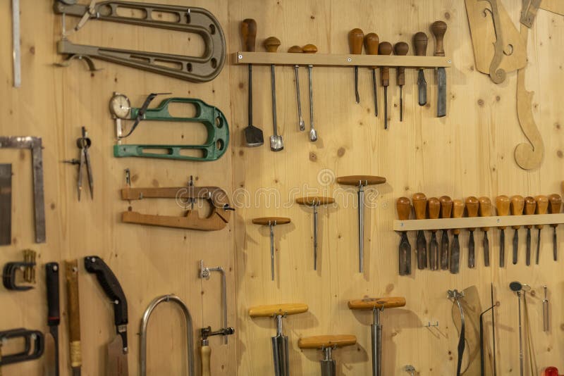 Set of Different Tools Hanging on a Wooden Wall in a Workshop Stock ...