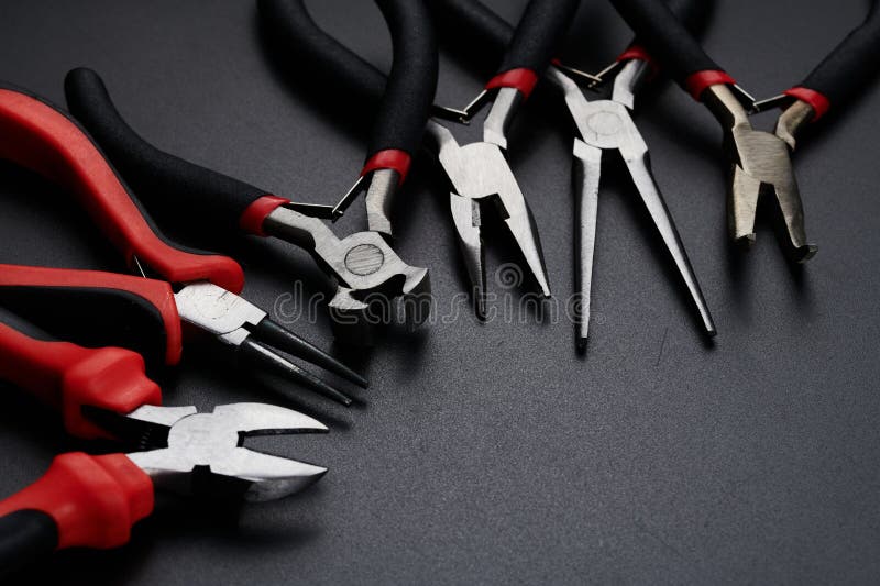Set of Different Types of Pliers and Side Cutters Isolated on Black ...