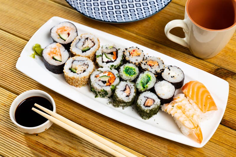 Set of Different Types of Sushi Served with Sauce Soy on Board in Cafe ...