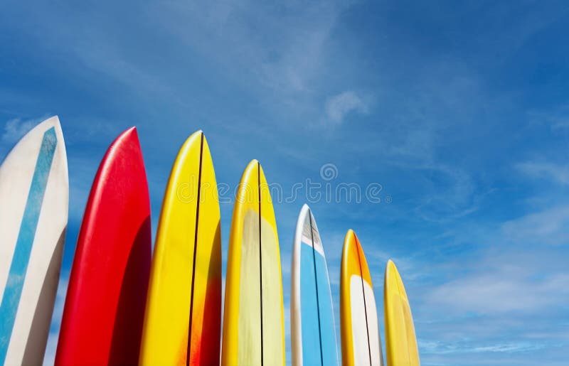 Set of Differently Colored Surfboards Stacked by the Ocean Stock ...