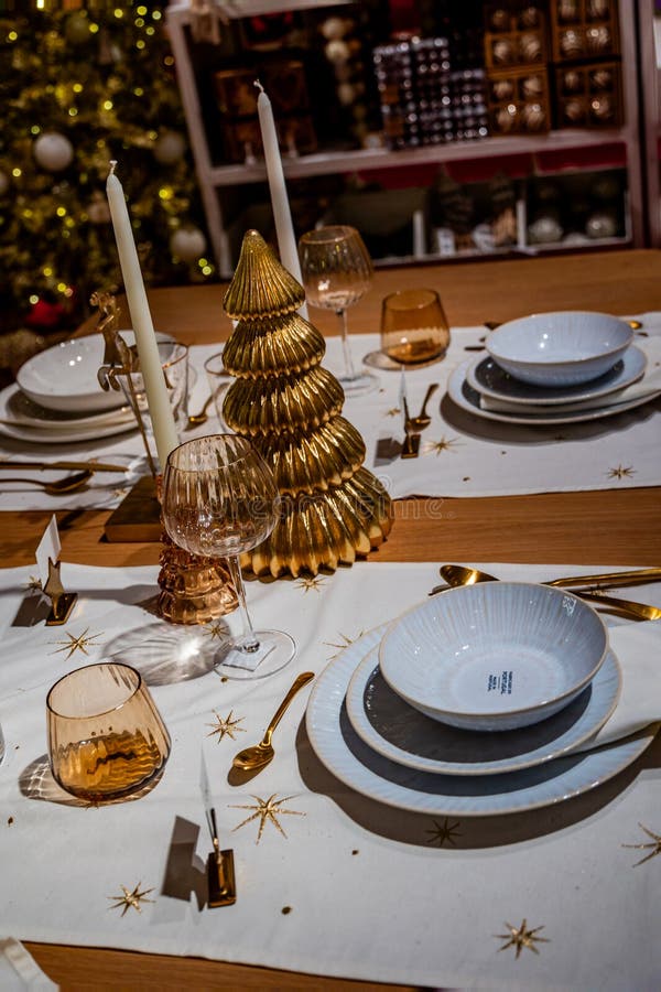 A Set Dining Table Features Elegant Dinnerware and Glassware, Along ...