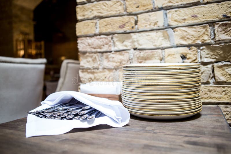 Set of Dishware on Table in Restaurant. Stacks of Cleaned White Plates ...