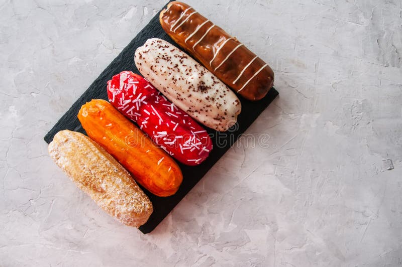 Set of Eclairs with Different Flavors Served on a Slate Board on Stock ...