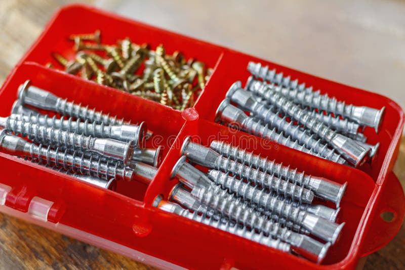 Set of Fasteners for Assembling Furniture in a Red Plastic Storage Box ...