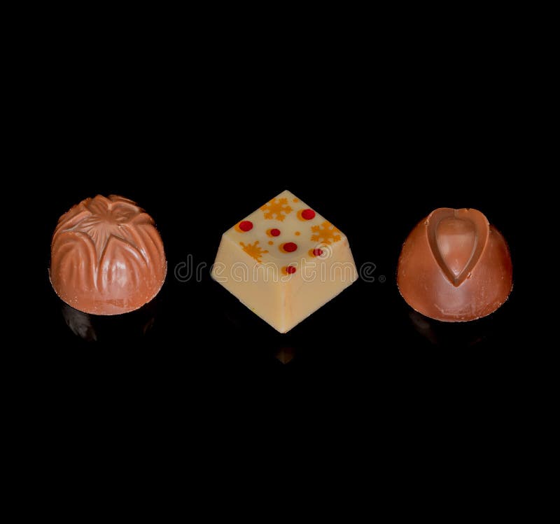 Set of Five Chocolate Candy on Black Table Stock Photo - Image of ...