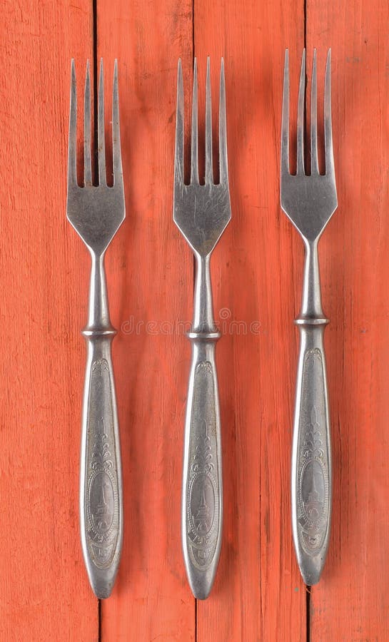 A Set of Forks on an Orange Wooden Surface. Top View Stock Image ...