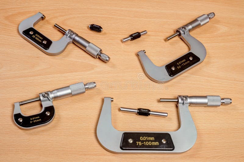 Set of Four Micrometers on Brown Table Stock Photo - Image of ...