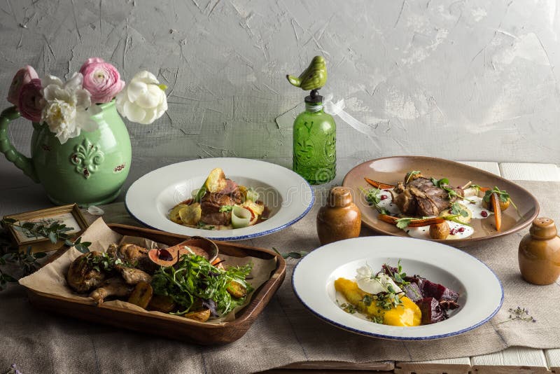 Set of Four Plates with Second Course Dishes Entree on the Table Stock ...