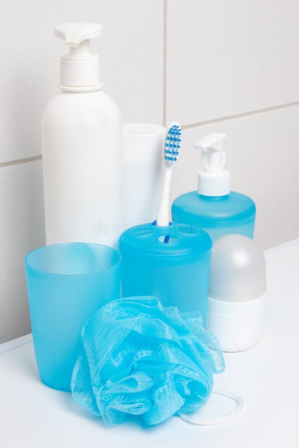 Set of Hygiene Supplies Over White Tiled Wall in Bathroom Stock Photo ...
