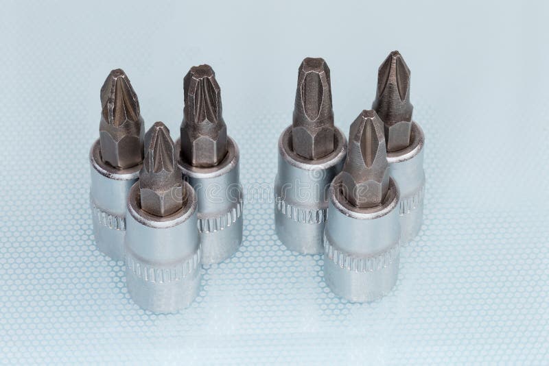 Set of Interchangeable Crosspoint Bits for Screwdriver on Blue Surface ...