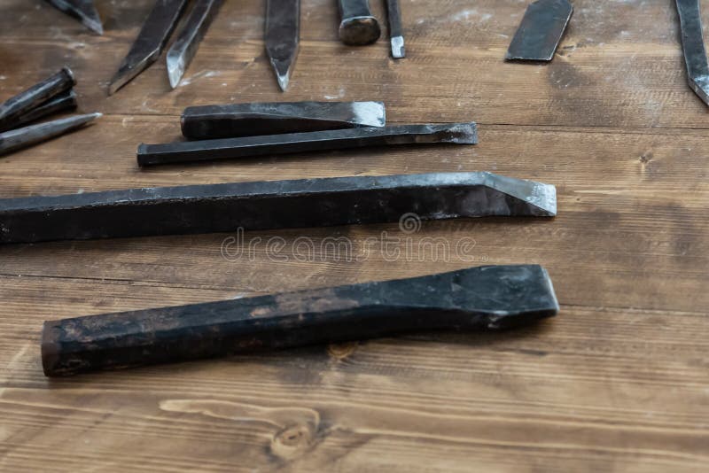 Set of Iron Chisels Sharp Mason Tool Lies on a Wooden Table To Create a ...