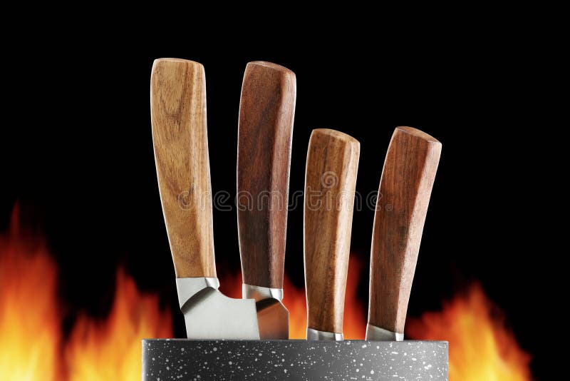 A Set of Kitchen Knives in a Stand on a Background of Flames of Fire ...