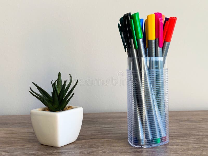 Set of Markers in a Plastic Cup on Wood Table. Stock Image - Image of ...