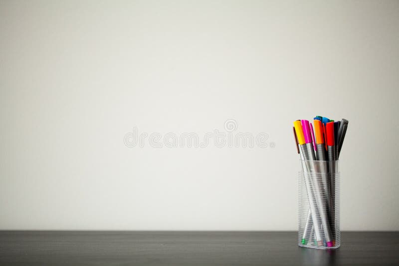 Set of Markers in a Plastic Cup on Wood Table. Stock Image - Image of ...