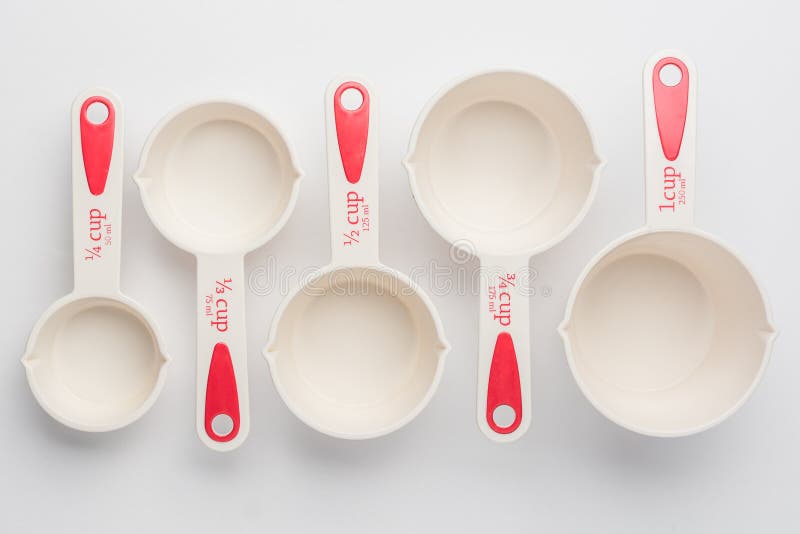 Set of Measuring Cups Staggered on White Background Top View Stock ...