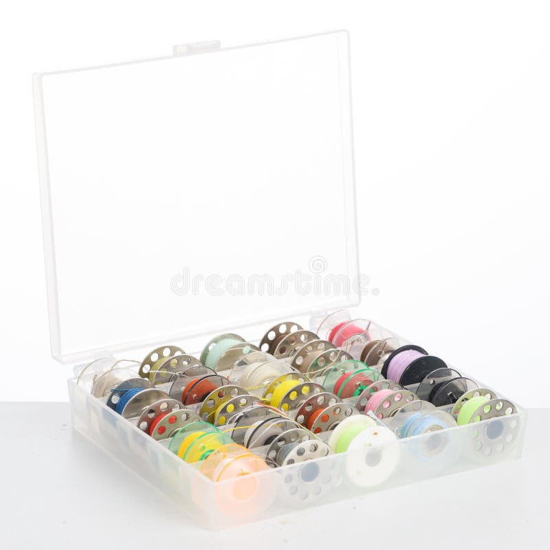 A Set of Metal Bobbins in a Sewing Machine Box on a White Background ...