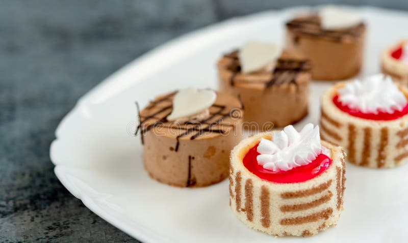 A Set of Mini Cakes with Different Fillings on a Flat Plate Stock Image ...