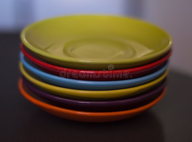 Set of Multi-colored Plates on a Kitchen Table Stock Image - Image of ...