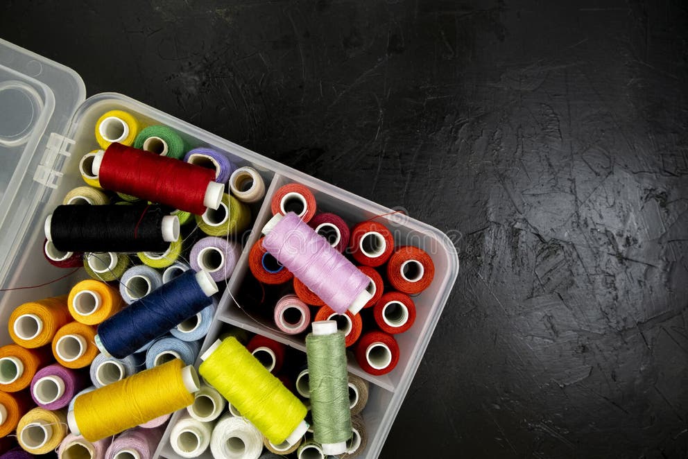 Set of Multi-colored Sewing Threads on Black, Copy Space, Top View ...