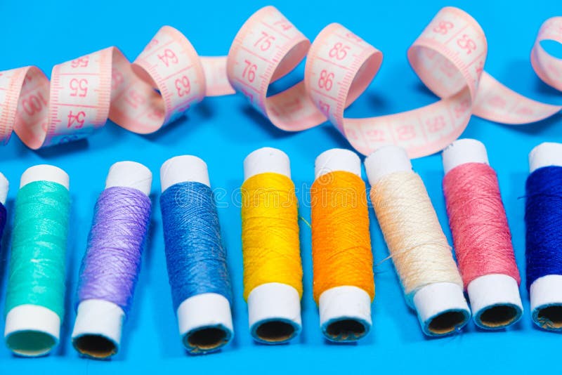 A Set of Multi-colored Threads for Sewing and a Measuring Tape on a ...