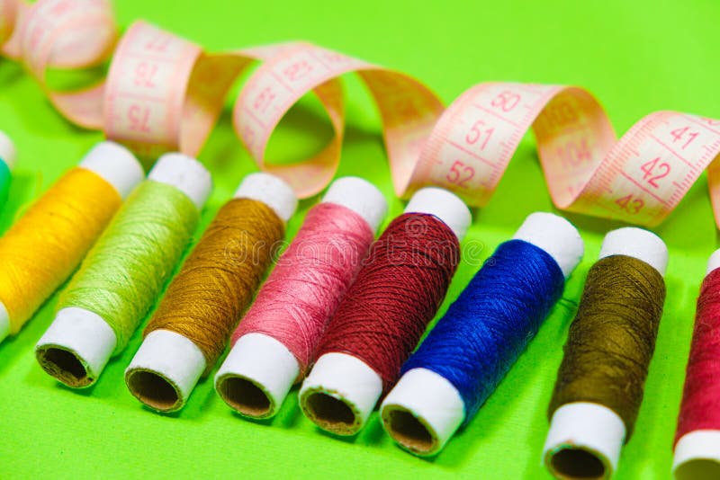 A Set of Multi-colored Threads for Sewing and a Measuring Tape on a ...
