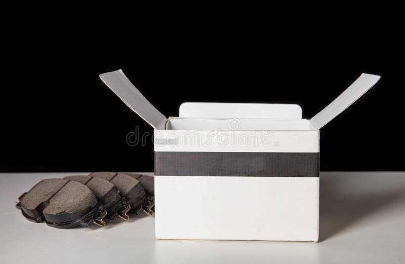 A Set of New Brake Pads in a Box on the Table. Copy Space for Text ...