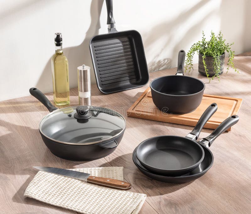 Set of Pans on the Wooden Table. Kitchen Cookware Stock Photo - Image ...