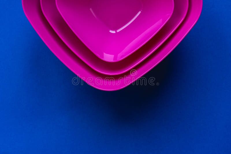 Set of Pink Plates on Blue Background. Plastic Utensils for the Kitchen ...