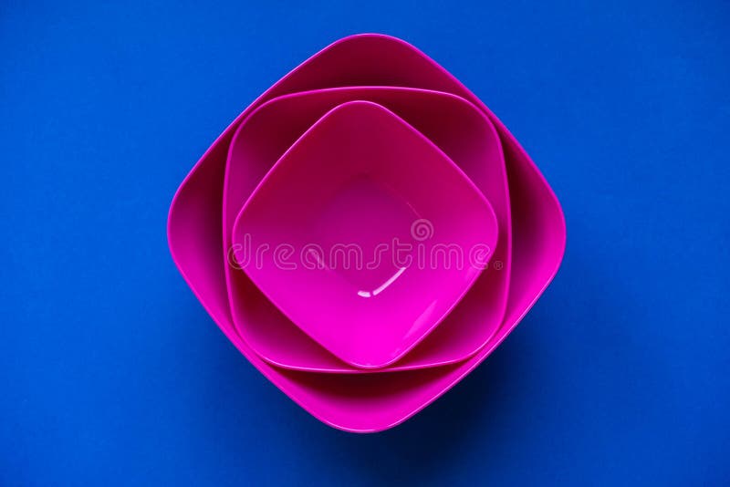 Set of Pink Plates on Blue Background. Plastic Utensils for the Kitchen ...