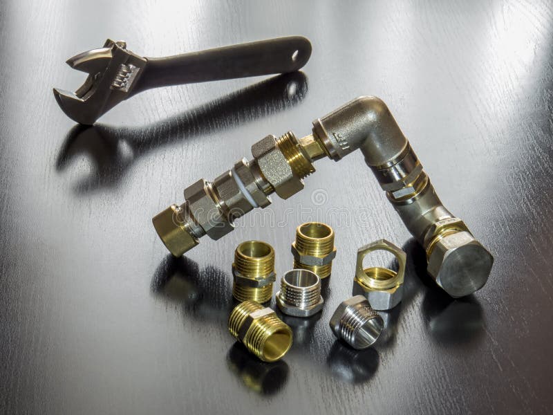 Set of Pipe Fittings and Adjustable Wrench Stock Photo - Image of ...