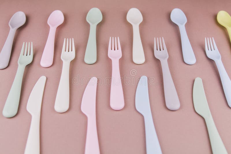 Set of Plastic Cutlery in Different Colors Spoons Forks Knives on the ...