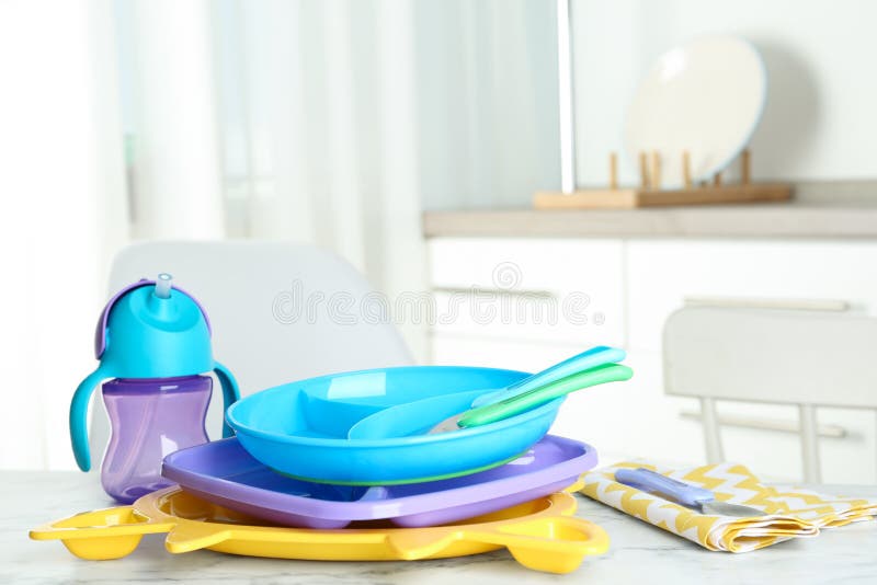Set of Plastic Dishware on White Marble Table. Serving Baby Food Stock ...