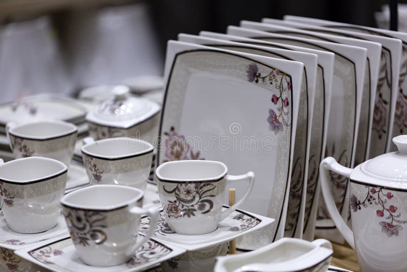 A Set of Plates and Cups in White Tone Stands on a Wooden Table Stock ...