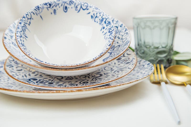 A Set of Plates of Different Sizes with a White Middle and Blue ...