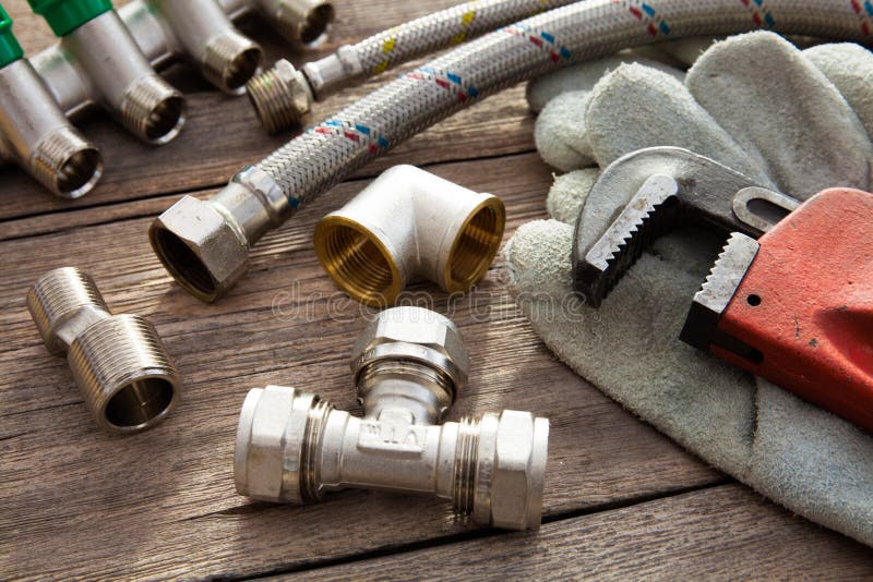 Set of Plumbing and Tools on the Wooden Table Stock Image - Image of ...