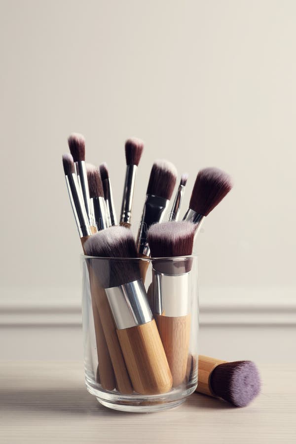 Set of Professional Makeup Brushes on Table Against White Background ...