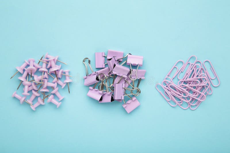 Set of Purple Paper Clips, Binders and Pins on Blue Background Stock ...