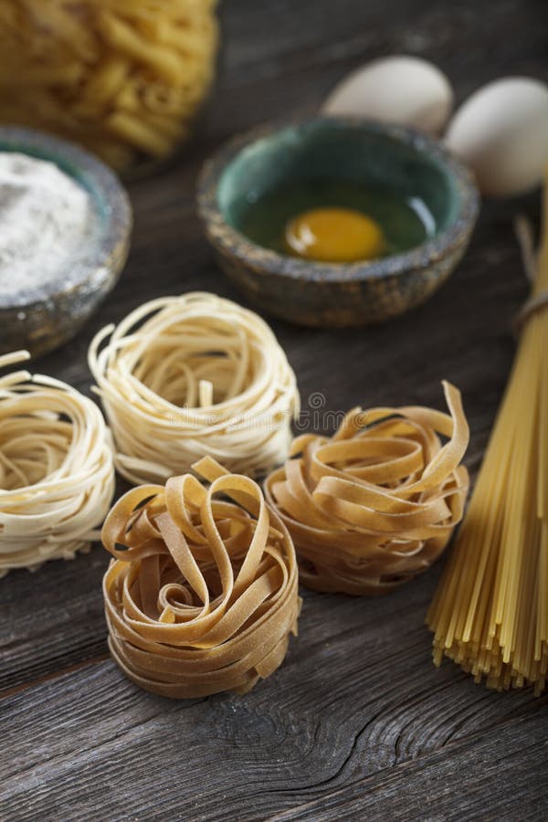 A Set of Raw Pasta and Addons on Wooden Table Stock Image - Image of ...