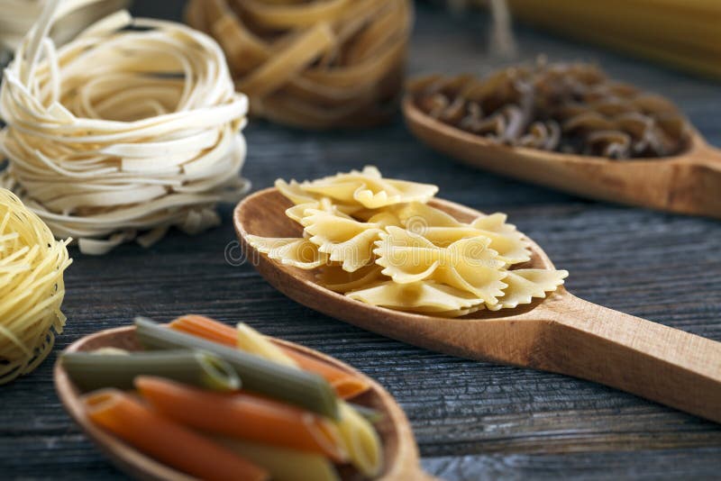 A Set of Raw Pastas on Spoons on a Wooden Table Stock Image - Image of ...