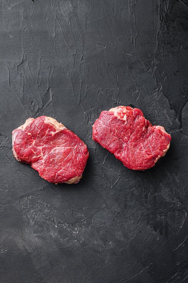 Set of Raw Rump Steaks Over Black Textured Background, Top View Stock ...