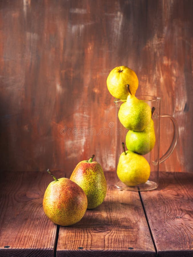 Set of Ripe Pears in a Glass Jug and Two Large Pears on the Table for ...