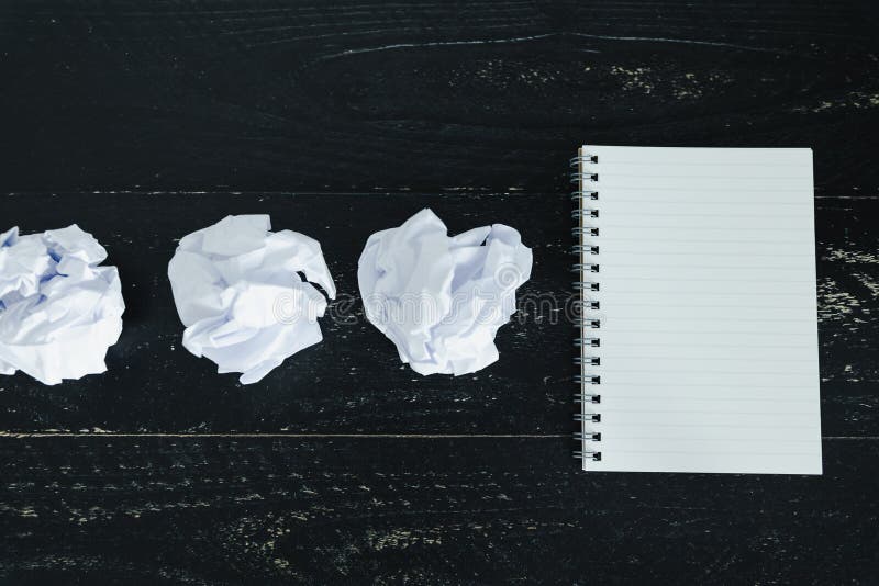 Set of Scrunched Paper Balls and Empty Notepad on Dark Moody Background ...