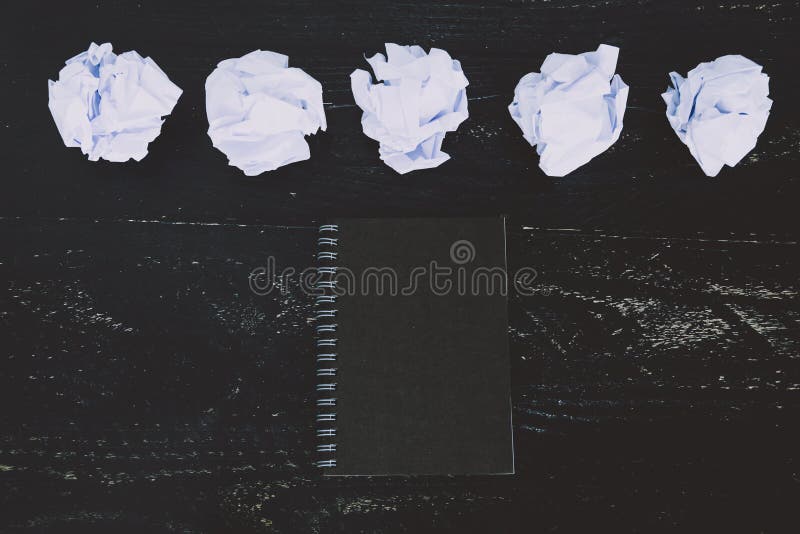 Set of Scrunched Paper Balls and Empty Notepad on Dark Moody Background ...