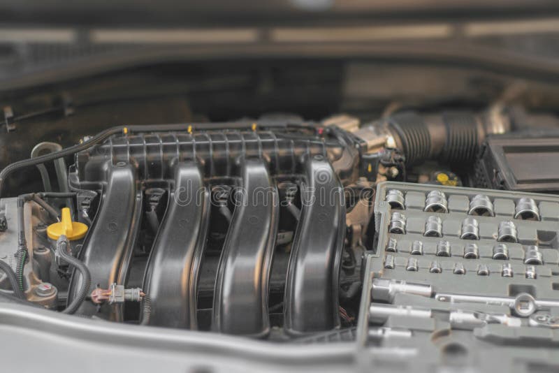 A Set of Socket Wrenches Lies on the Internal Combustion Engine of a ...