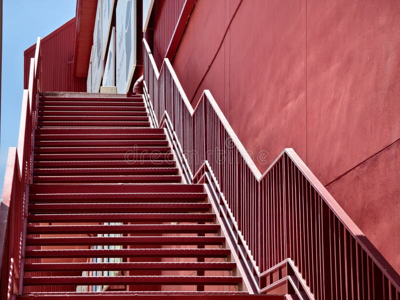 A Set of Stairs Ascending a Large Red Wall Stock Image - Image of ...