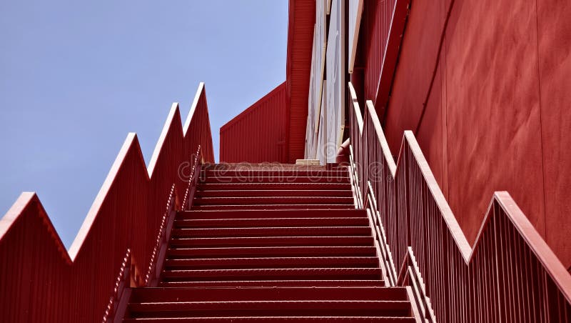 A Set of Stairs Ascending a Large Red Wall Stock Image - Image of room ...